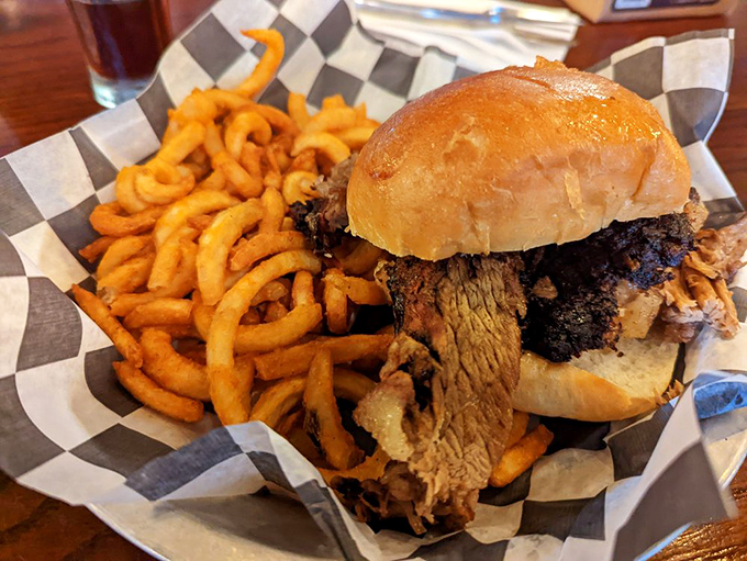 A brisket sandwich that requires both hands and your full attention. Those curly fries aren't just sides—they're golden, spiraled works of art.