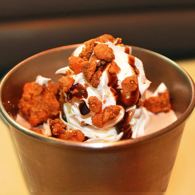 Dessert that understands its mission—ice cream elevated to art form with the strategic deployment of Butterfinger crumbles and chocolate sauce. Spoons up!