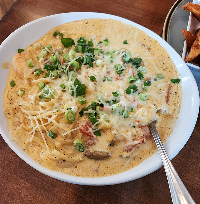 Creamy pasta nirvana with green onions standing by as lifeguards – dive in and prepare to be happily lost in this cajun carbonara sea.