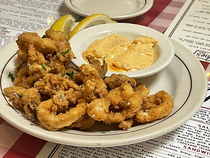 Golden-fried calamari that doesn't need fancy presentation – just a squeeze of lemon and that perfect crunch that keeps you reaching for more.