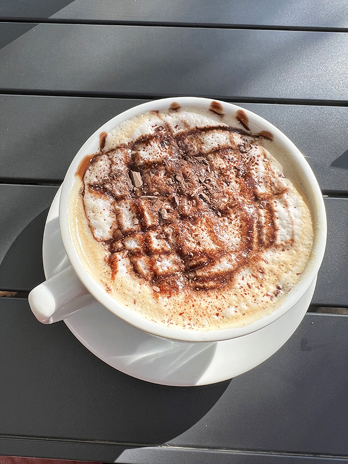 Coffee artistry that makes you pause before sipping – those chocolate drizzles aren't just decoration, they're a preview of the comfort to come.