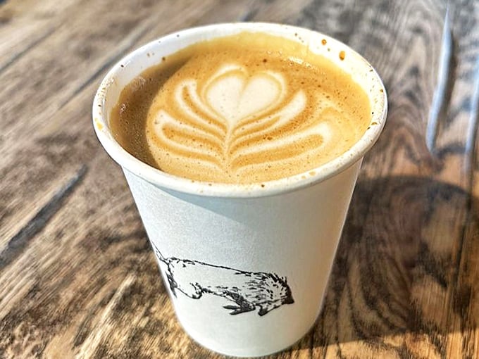 Latte art that's both ephemeral and Instagram-worthy. The fox logo cup reminds you this isn't just coffee—it's part of a carefully crafted experience.