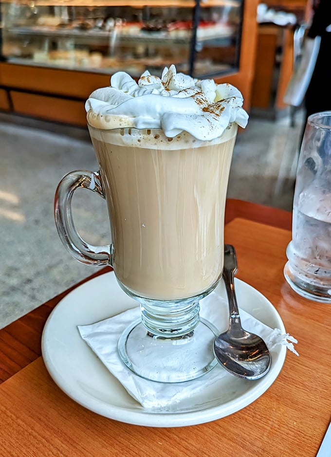This isn't just coffee – it's a warm hug in a glass mug, topped with a cloud of whipped cream that's begging to give you a mustache.