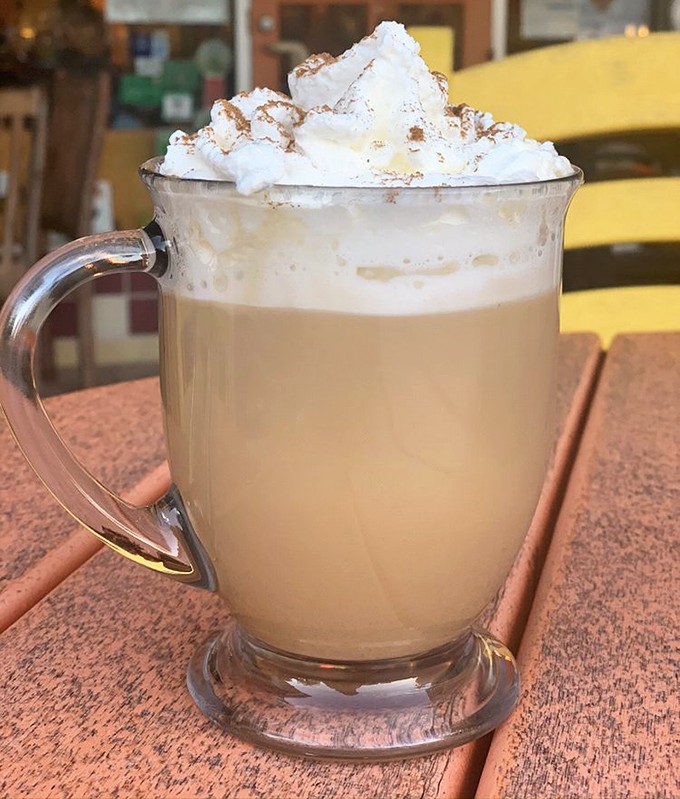 Coffee elevated to an art form. This caramel latte topped with whipped cream isn't just a beverage—it's a warm hug in a glass mug.