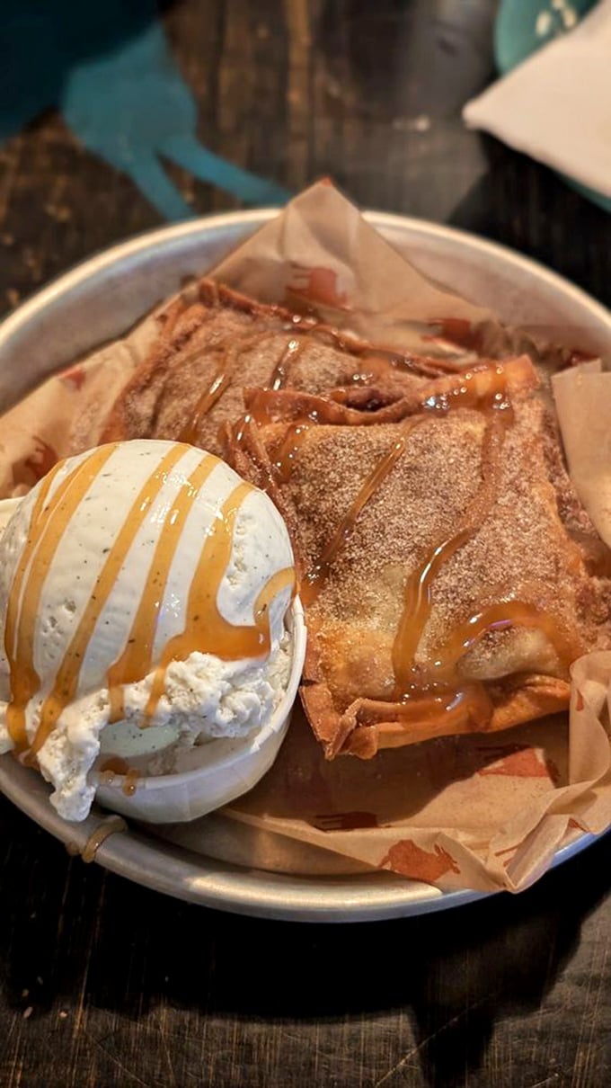 Dessert that makes you question your life choices—warm apple pie pastry with ice cream and caramel that's worth saving room for.