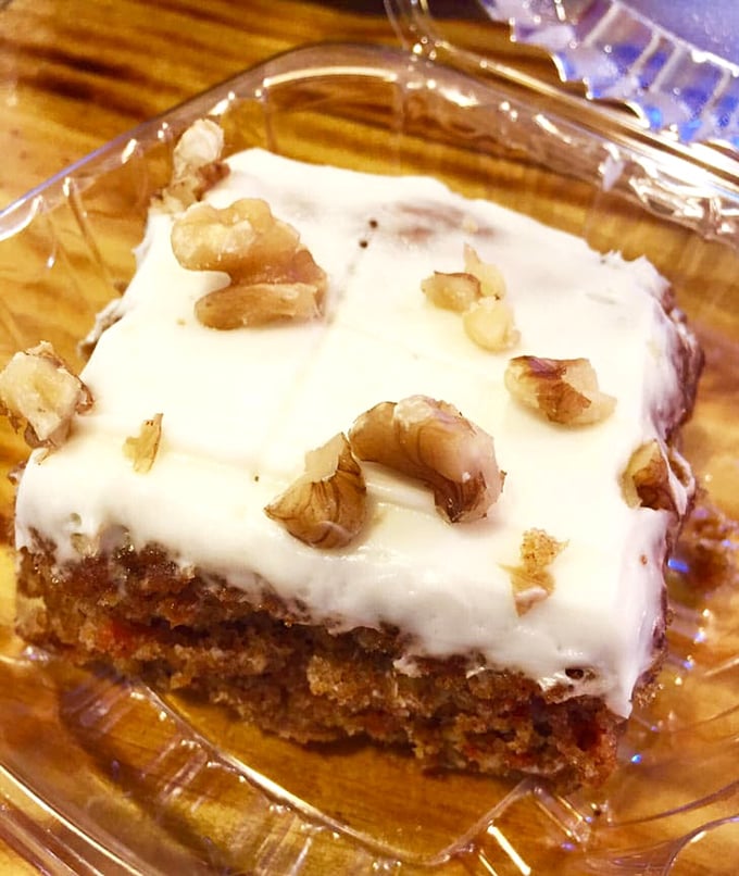 Carrot cake with cream cheese frosting and walnuts—because after a barbecue feast, you deserve dessert that's equally committed to excellence.