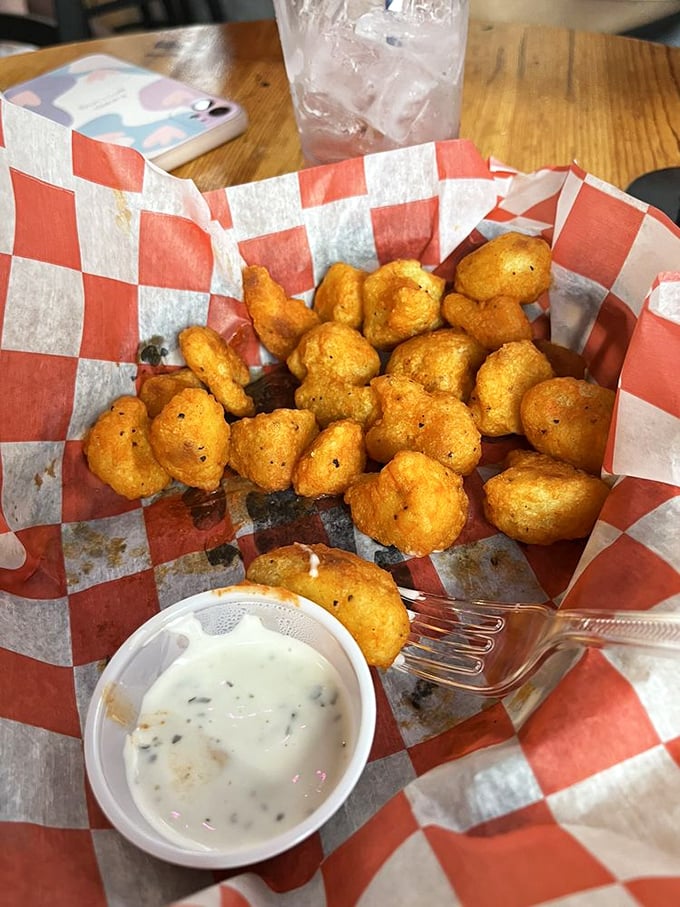Golden-fried cauliflower bites that make eating vegetables feel like cheating. That dipping sauce deserves its own fan club.