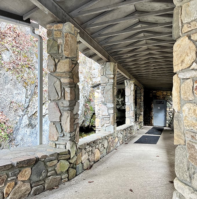 The covered entrance walkway feels like the threshold between worlds—one last glimpse of sunlight before entering the mountain's embrace.