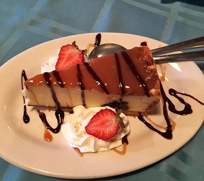 Cheesecake drizzled with chocolate and adorned with strawberries—because saving room for dessert is always the right decision.