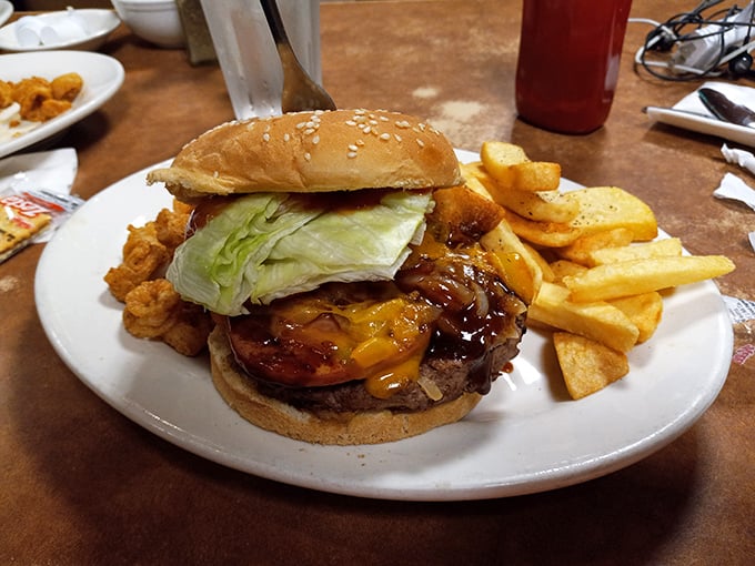 This burger isn't just a meal, it's an architectural achievement – layers of flavor stacked between buns with fries standing guard.