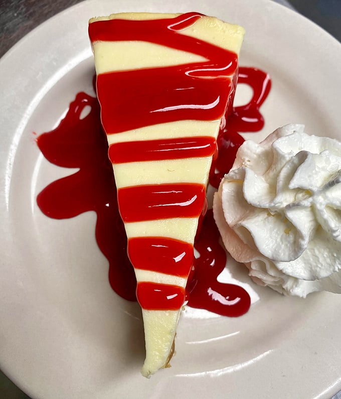 Cheesecake with strawberry sauce that makes you wonder if dessert should actually come first. Life's uncertain—eat the sweet stuff first!