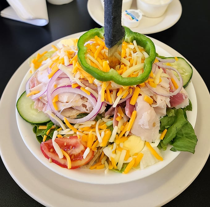 A chef salad that actually looks like someone who cares about food made it. That green pepper ring is both garnish and genius—a built-in first bite selector.
