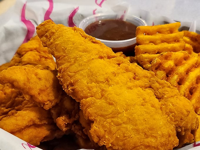 These chicken fingers aren't just for kids—they're for anyone who appreciates the simple pleasure of perfectly golden-fried comfort food with waffle fries.