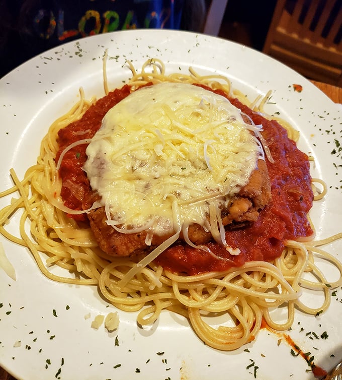 Chicken Parmesan that doesn't know the meaning of restraint – a mountain of melted cheese atop perfectly crisp cutlet and twirled spaghetti.