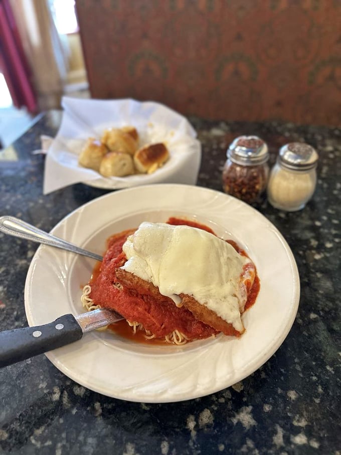 Classic Chicken Parmesan arrives crispy and golden, proving some dishes achieve perfection and never need changing.