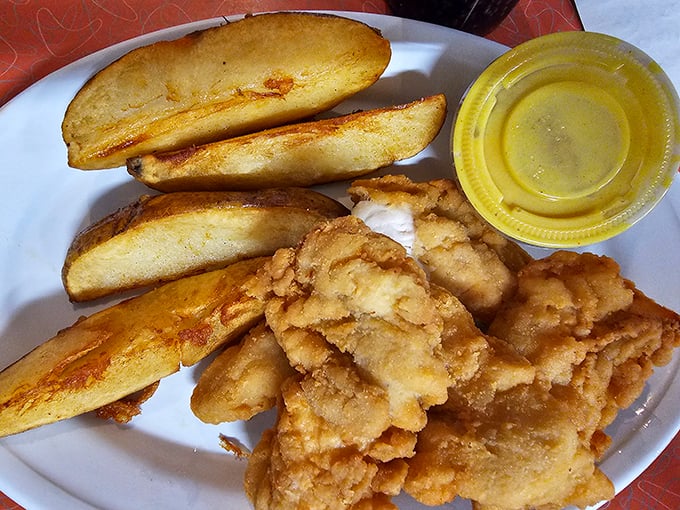 Crispy chicken tenders and perfectly seasoned potato wedges—proof that sometimes the simplest pleasures deliver the most profound satisfaction.