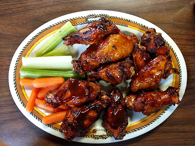 Wings that look like they've been painted with BBQ love – crispy, sticky, and destined to leave evidence on your shirt as a souvenir.
