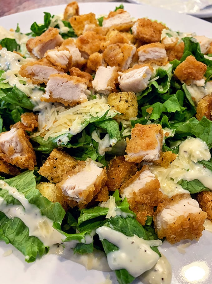 Crispy chicken perched atop fresh greens—proof that "eating a salad" and "treating yourself" aren't mutually exclusive concepts after all.