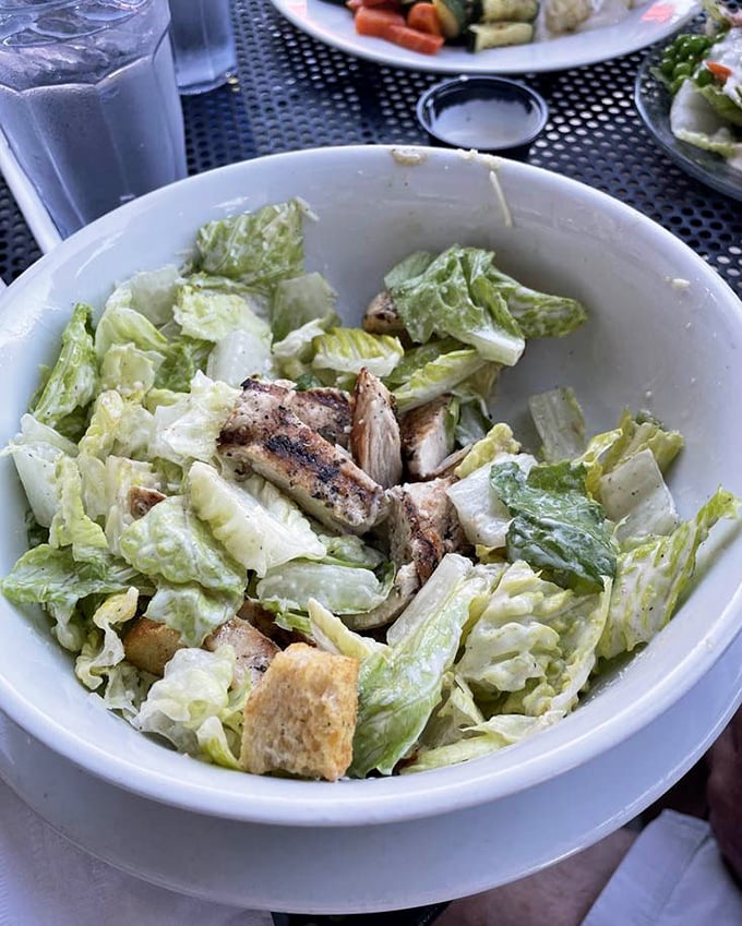 A Caesar salad that actually delivers on the promise of freshness—crisp romaine embracing grilled chicken like they were meant to be together.