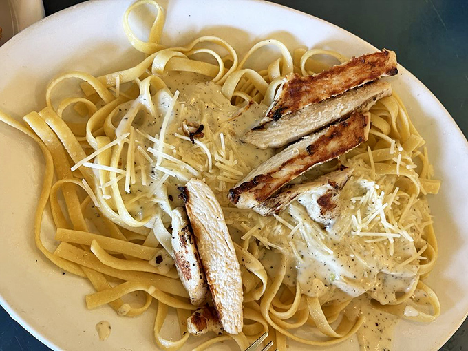 Fettuccine Alfredo with grilled chicken—proof that even seafood restaurants understand sometimes you need a pasta life preserver in an ocean of fish options.