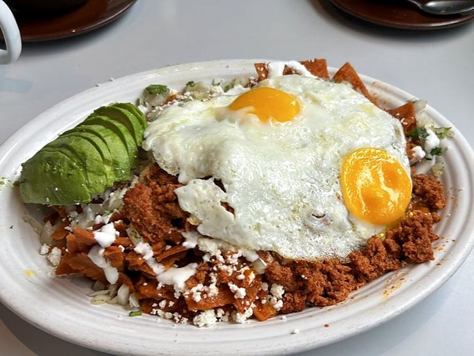 Chilaquiles that bring a fiesta to your morning – crispy tortillas swimming in sauce, crowned with eggs that add creamy richness.