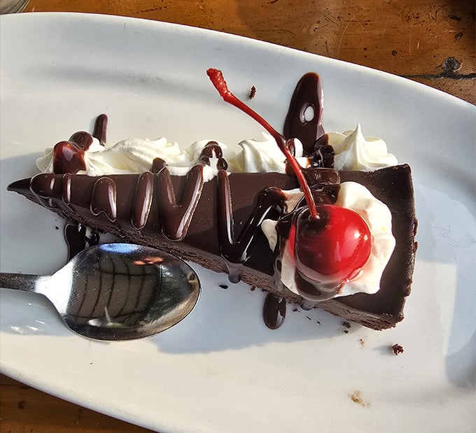 Chocolate cake so decadent it should come with a warning label. That cherry on top isn't garnish—it's the exclamation point on a dessert manifesto.
