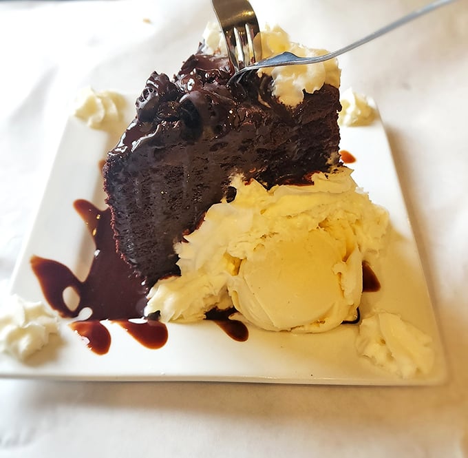 Chocolate cake so decadent it should come with its own warning label – resistance is futile, just surrender to the fudgy goodness.