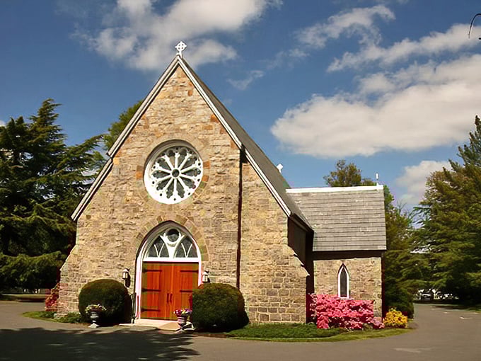 The Church of the Holy Trinity stands as a stone testament to faith and architecture, its vibrant azaleas providing a pink exclamation point to its solemnity.