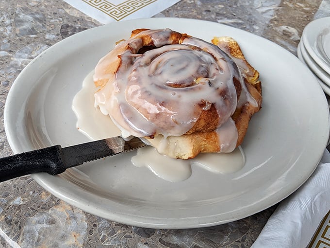 This cinnamon roll isn't just a pastry—it's an event. Warm, gooey, and dripping with icing that's making a break for freedom.