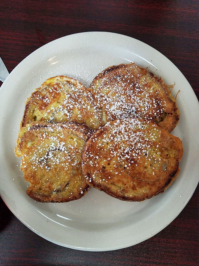 Cinnamon French toast dusted with powdered sugar – breakfast that boldly crosses into dessert territory without apology.