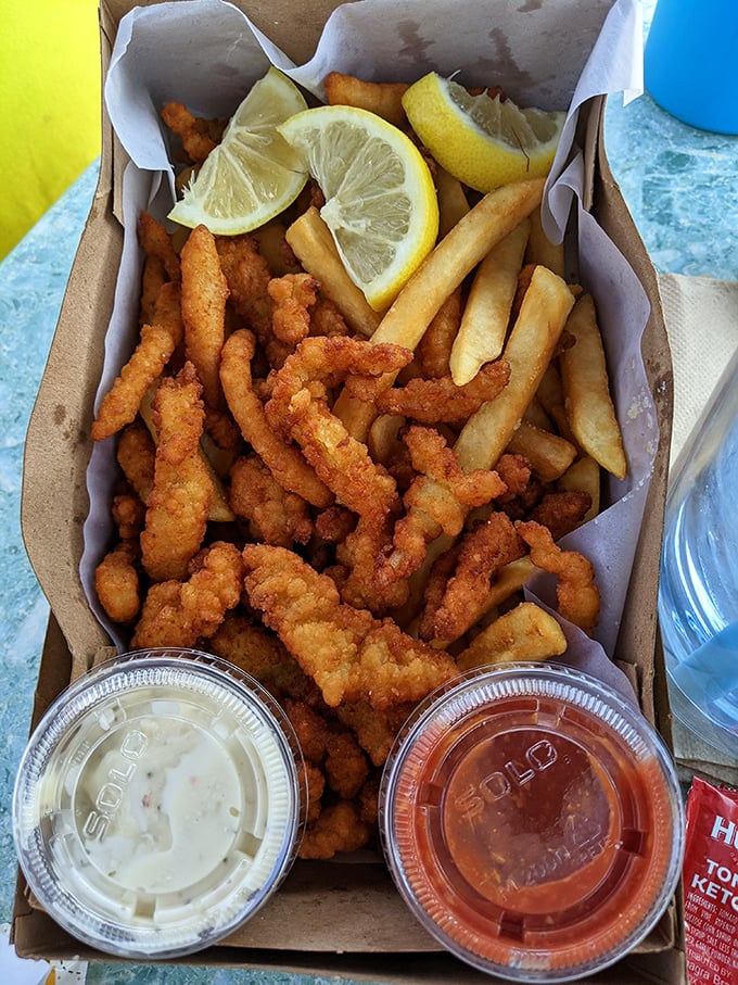 Fried clam strips and fries—the beach meal that time forgot. Crispy, golden, and served with dipping sauces that make you forget about fancy seafood towers.