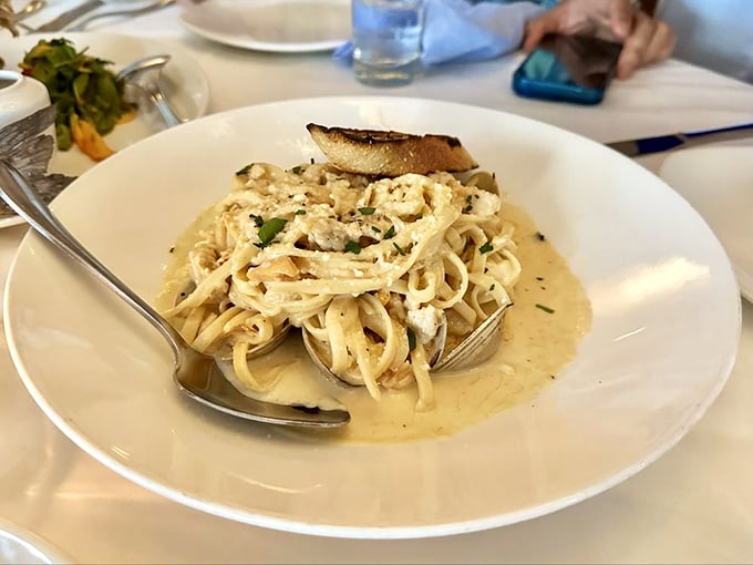 Linguine and clams swimming in a buttery sea of perfection—pasta that makes you want to cancel your actual trip to Italy.