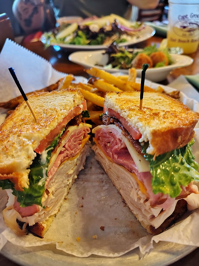 This isn't just a club sandwich—it's architecture. Layers of goodness stacked so perfectly you almost feel guilty dismantling it. Almost.