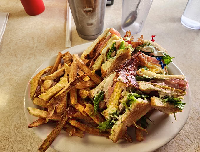The club sandwich – architecture you can eat. Three stories of deliciousness held together with toothpicks and tradition.
