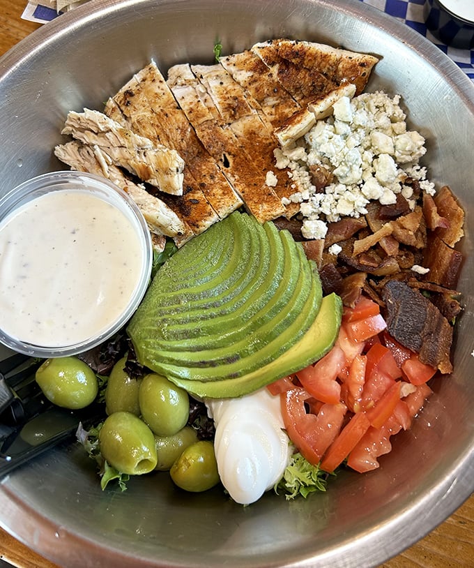 This isn't just a salad—it's a perfectly composed symphony of protein, greens, and that sliced avocado deserves its own fan club.