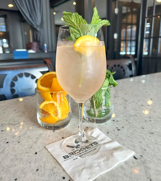 A cocktail that looks like summer vacation in a glass. That fresh mint and citrus garnish isn't just for show—it's the exclamation point on a liquid sentence.