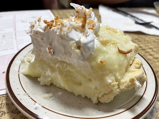 This coconut cream pie doesn't just have layers of flavor—it has stories to tell. The toasted coconut on top is like the perfect plot twist.