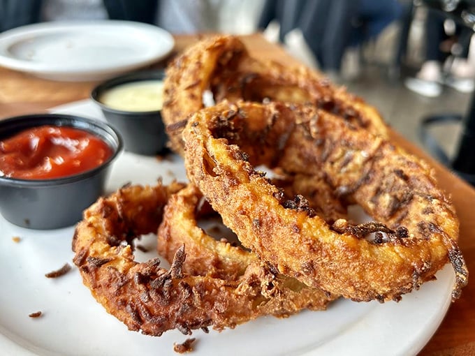 Onion rings with the golden-ratio of crunch-to-sweetness. Those dipping sauces aren't just condiments – they're flavor destiny.