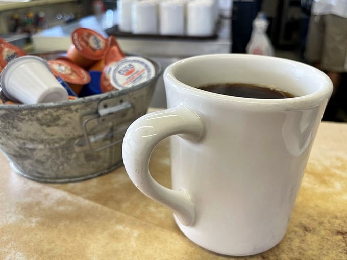 That sturdy white mug isn't just holding coffee – it's holding the fuel that's powered Route 66 travelers and locals for generations.