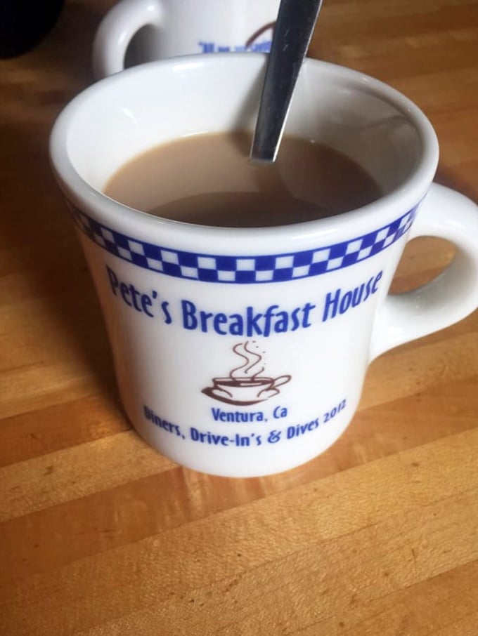 The blue-checkered coffee mug – a humble vessel for liquid motivation and the unofficial mascot of morning victory.