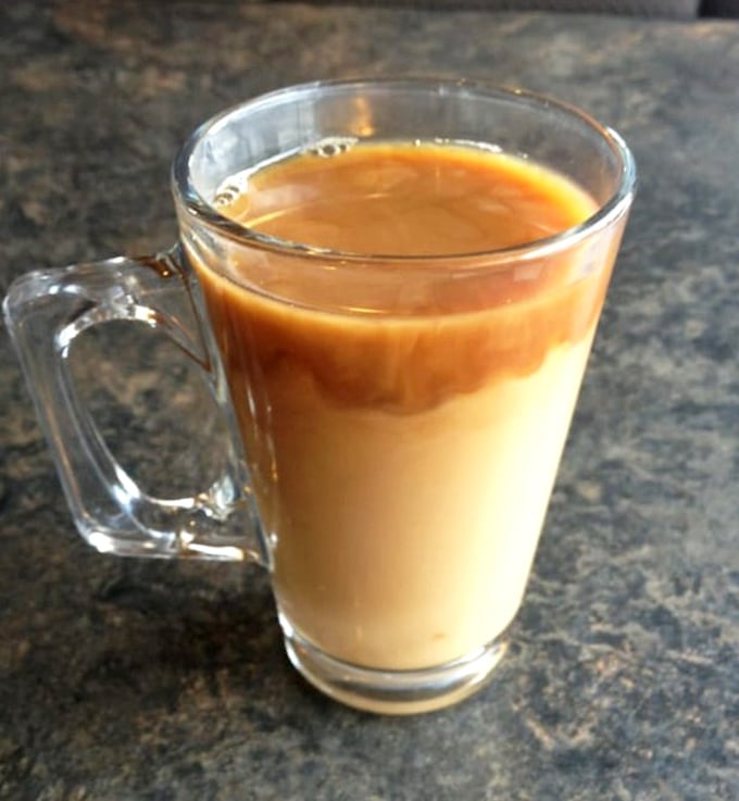 Coffee with that perfect caramel hue – not pretentiously artisanal, not shamefully instant. The kind that says, "Good morning" like it means it.
