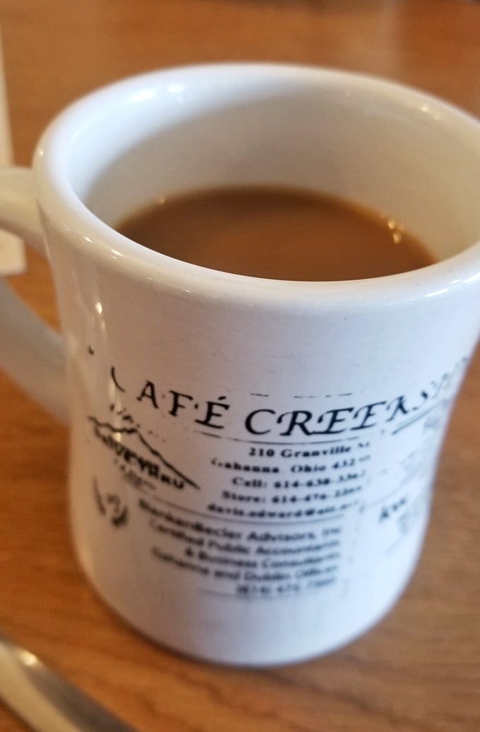 The coffee mug tells you everything—this isn't just a place to eat, it's an institution where the caffeine flows as freely as the conversation.