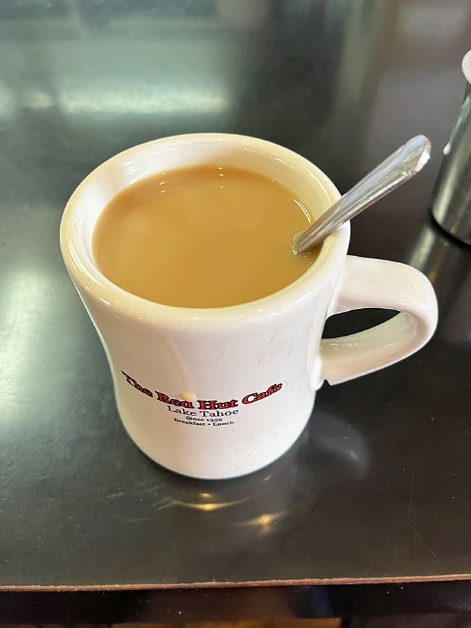 That classic diner mug—sturdy, unpretentious, and filled with coffee that keeps coming until you physically cover it with your hand.