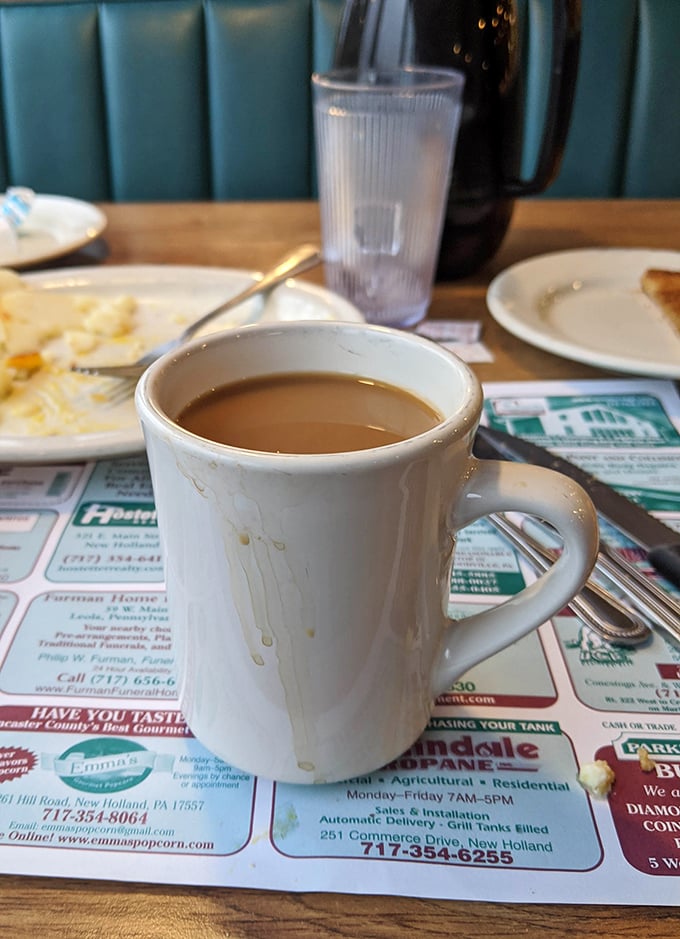 Coffee served in the classic white mug—the universal symbol for "take a moment and breathe." Simple pleasures in a chaotic world. 