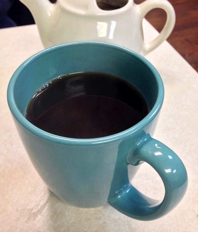 That turquoise mug isn't just serving coffee—it's delivering liquid motivation in a vessel that matches the diner's cheerful aesthetic.
