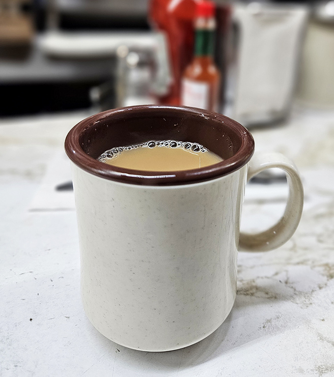 The humble coffee mug—unassuming vessel of liquid motivation. At Duly's, it's always full, always hot, and never pretentious.