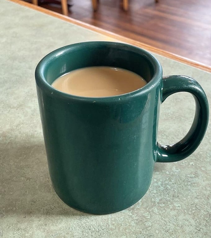 The humble green mug doesn't promise single-origin beans or artisanal foam art—just honest coffee that keeps coming until you surrender.