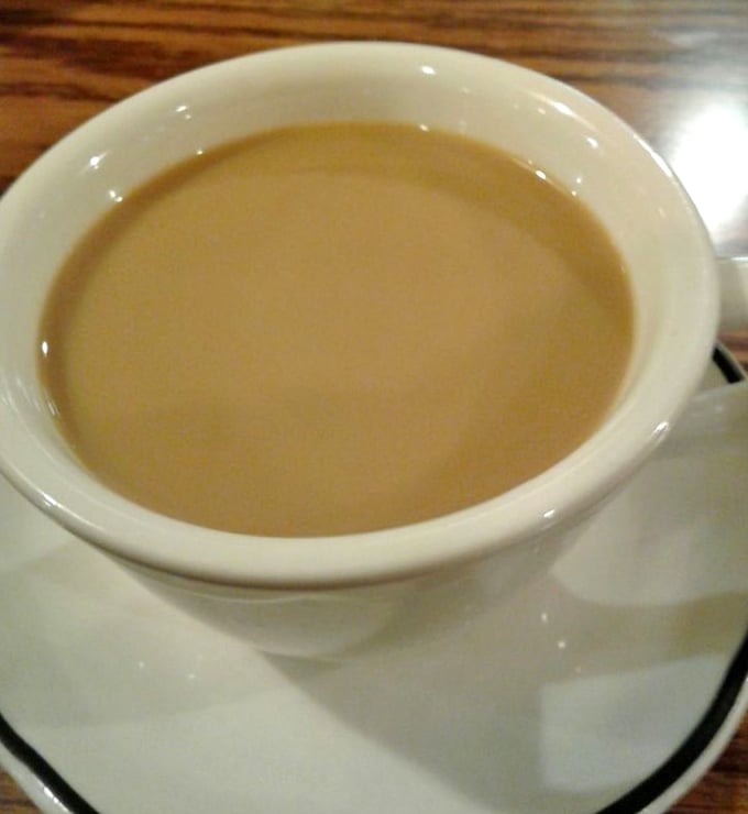 The lifeblood of any respectable diner – coffee served in that iconic thick white mug, promising to transform morning zombies into functioning humans.