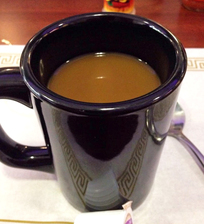 That black coffee mug with the Greek key pattern—holding liquid motivation that keeps Columbus running. Simple, strong, and reliable, just like the diner itself.
