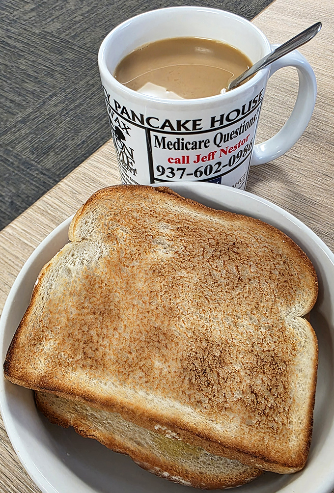 Sometimes the simplest pleasures are the most profound—perfectly toasted bread and a steaming mug of diner coffee in a mug that tells stories.